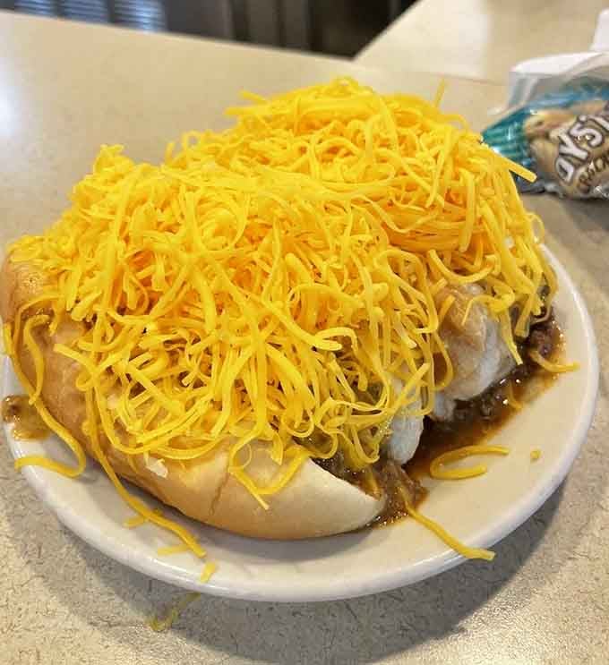 Chili cheese dogs buried under enough cheddar to make a dairy farmer weep tears of joy and pride.