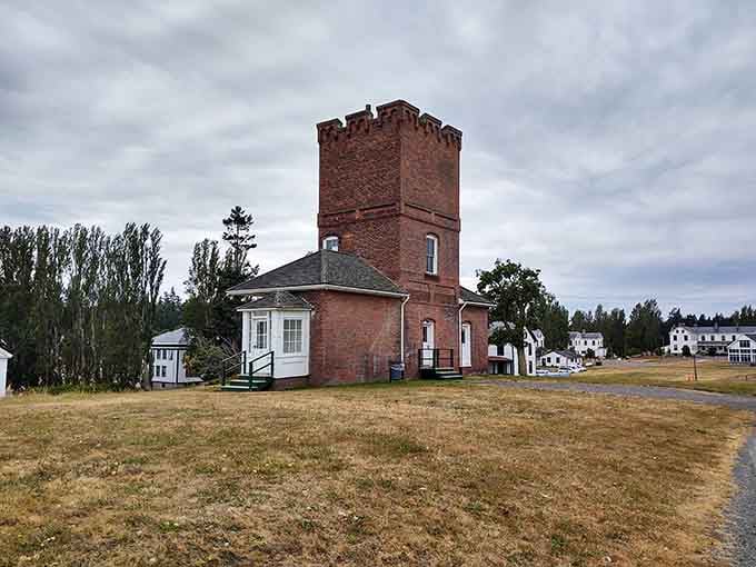 Fort Worden's old water tower stands guard over parade grounds where soldiers once marched and tourists now picnic.
