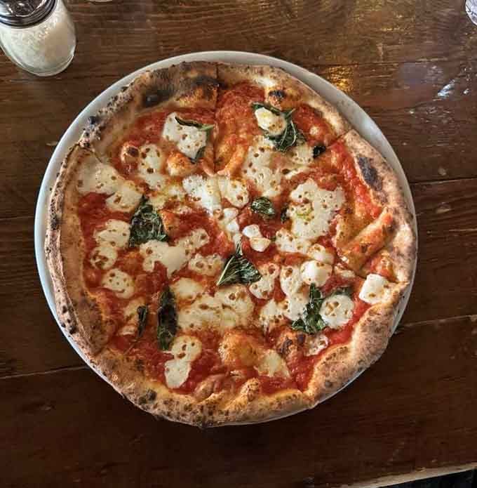 A classic Margherita pizza with leopard-spotted crust that would make any Neapolitan grandmother nod in approval.