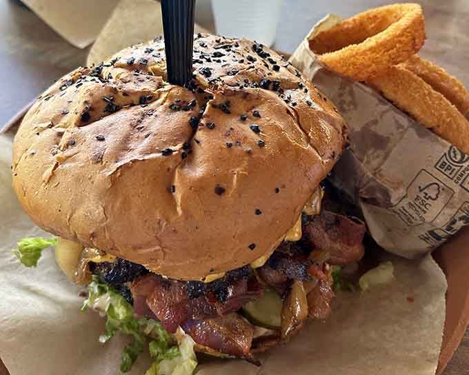 Loaded with bacon and toppings, this burger means business and possibly requires a post-meal nap to recover.