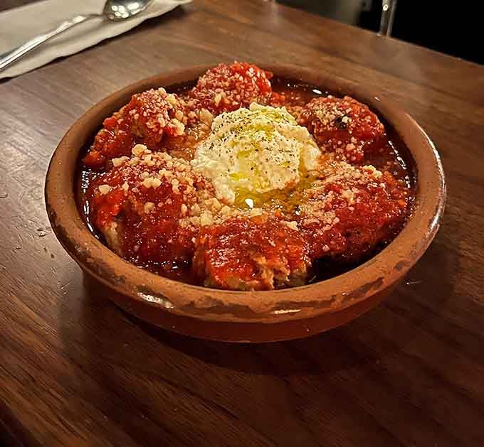 These meatballs swimming in sauce with a crown of ricotta could convert even the staunchest pizza-only purist.