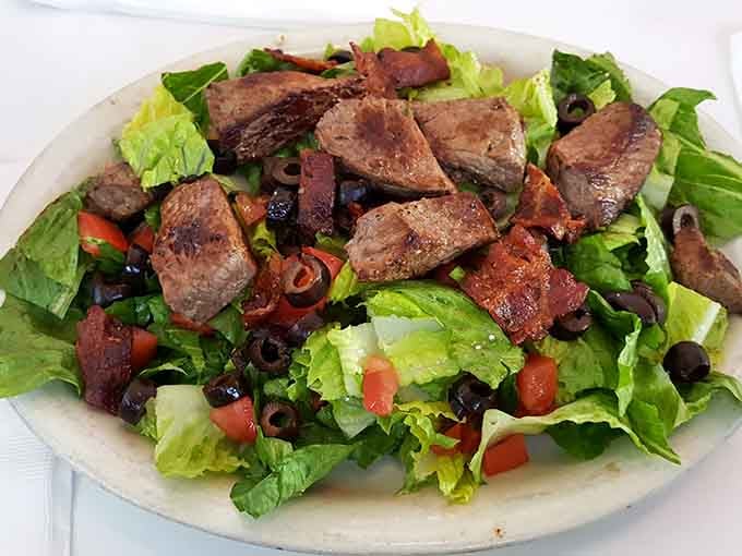 Fresh greens topped with perfectly grilled steak, because even time travelers need to eat their vegetables occasionally.