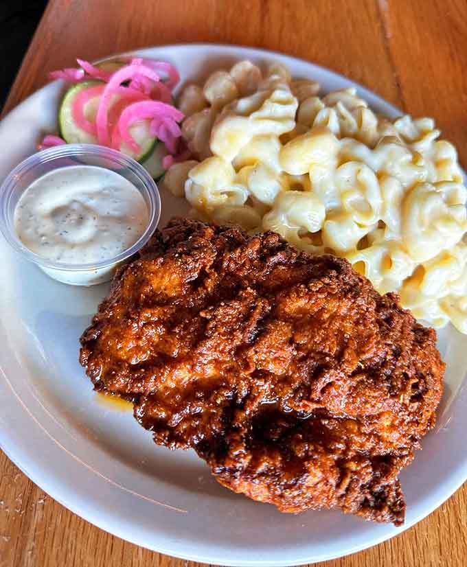 Hot chicken meets creamy mac and cheese in a plate that understands comfort food has no rules or boundaries.
