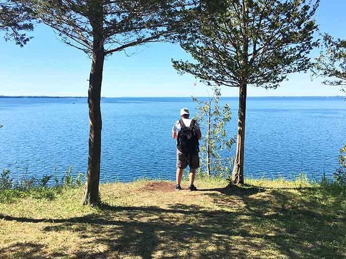 Standing at the edge of forever, where the blue sky meets even bluer water.