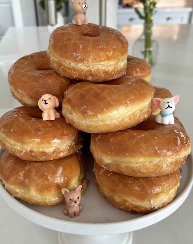 Someone stacked these glazed donuts like edible Jenga, and we're not mad about it one bit.