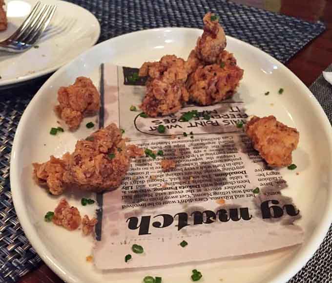Crispy popcorn chicken that looks like it could start a family feud over who gets the last piece on the plate.