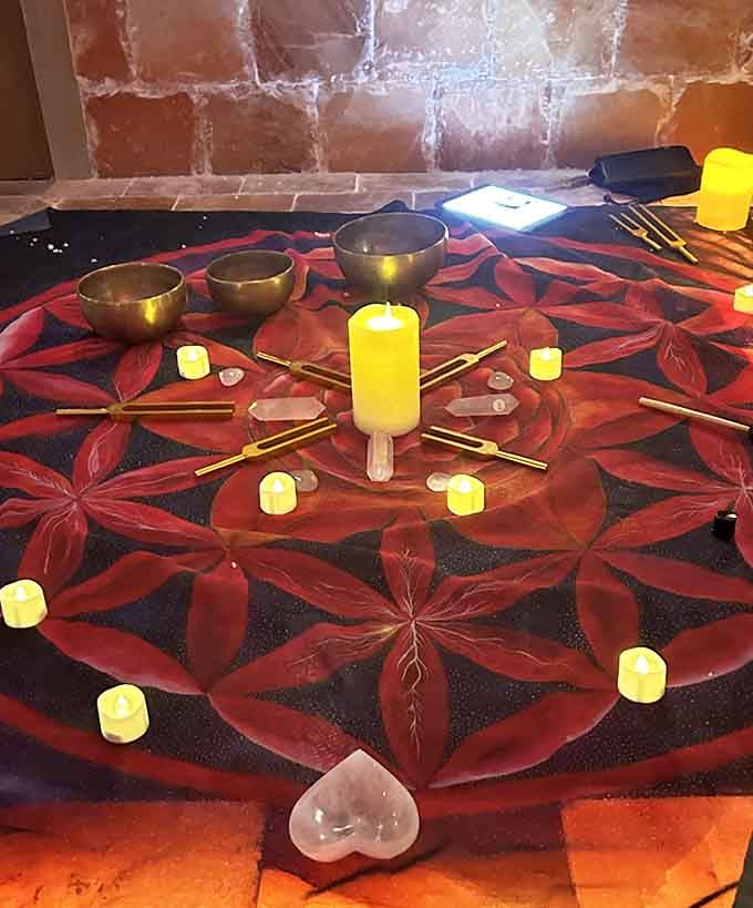 This mandala setup with singing bowls transforms the salt cave into a meditation sanctuary that would make your yoga instructor weep with joy.