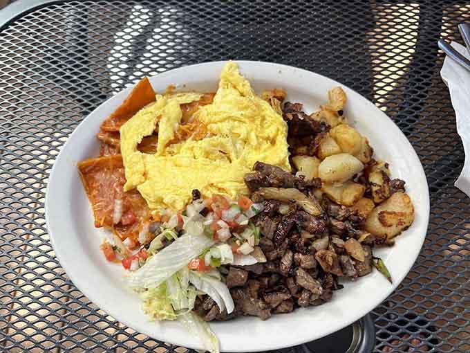 Chilaquiles topped with tender carne asada, where crispy tortillas meet savory beef in perfect harmony.