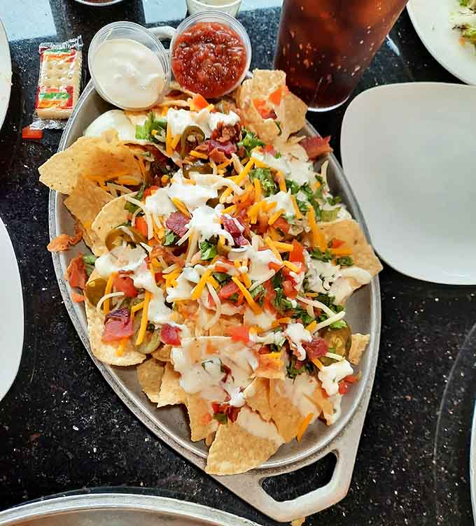 This mountain of crispy chips buried under cheese, meat, and fresh toppings could feed a small army or one very happy person.