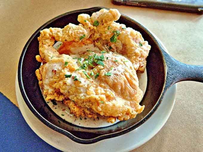 Pollo con miel arrives in a skillet like it's making a grand entrance at the Oscars.
