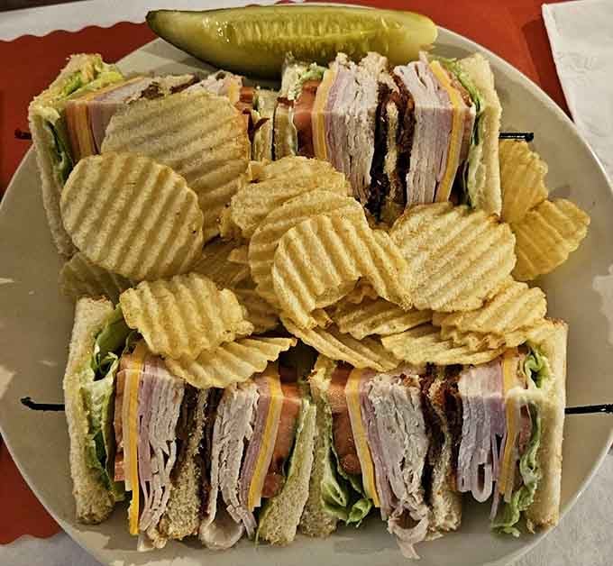 This club sandwich towers like a delicious skyscraper, proving landlubber options deserve respect too.