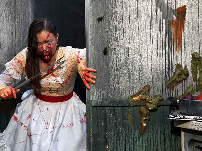 She's covered in stage blood and wielding sharp objects, proving Minnesota nice doesn't apply during haunted house season.