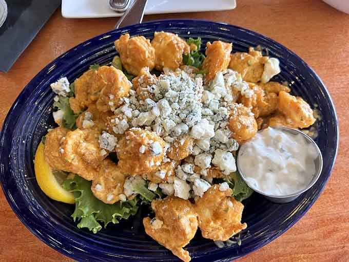 Firecracker shrimp lives up to its explosive name with crispy coating, spicy kick, and crumbled blue cheese perfection.
