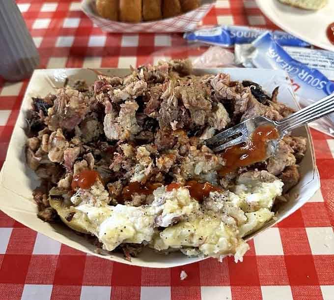 A baked potato stuffed with barbecue is basically comfort food having a family reunion on your plate.