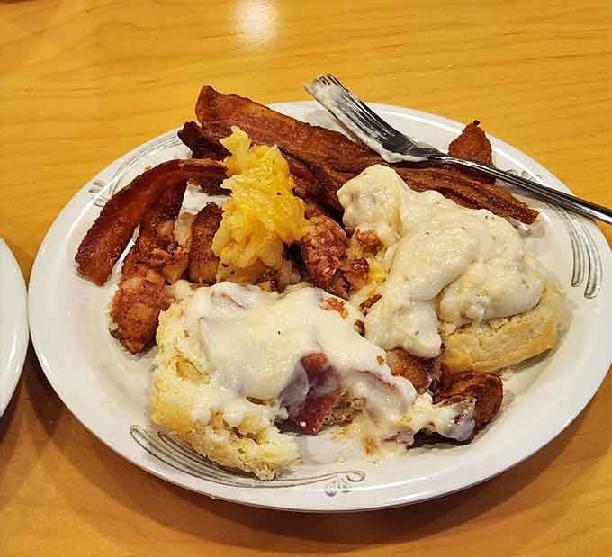 Breakfast done right means biscuits drowning in gravy, bacon standing at attention, and zero regrets about elastic waistbands.