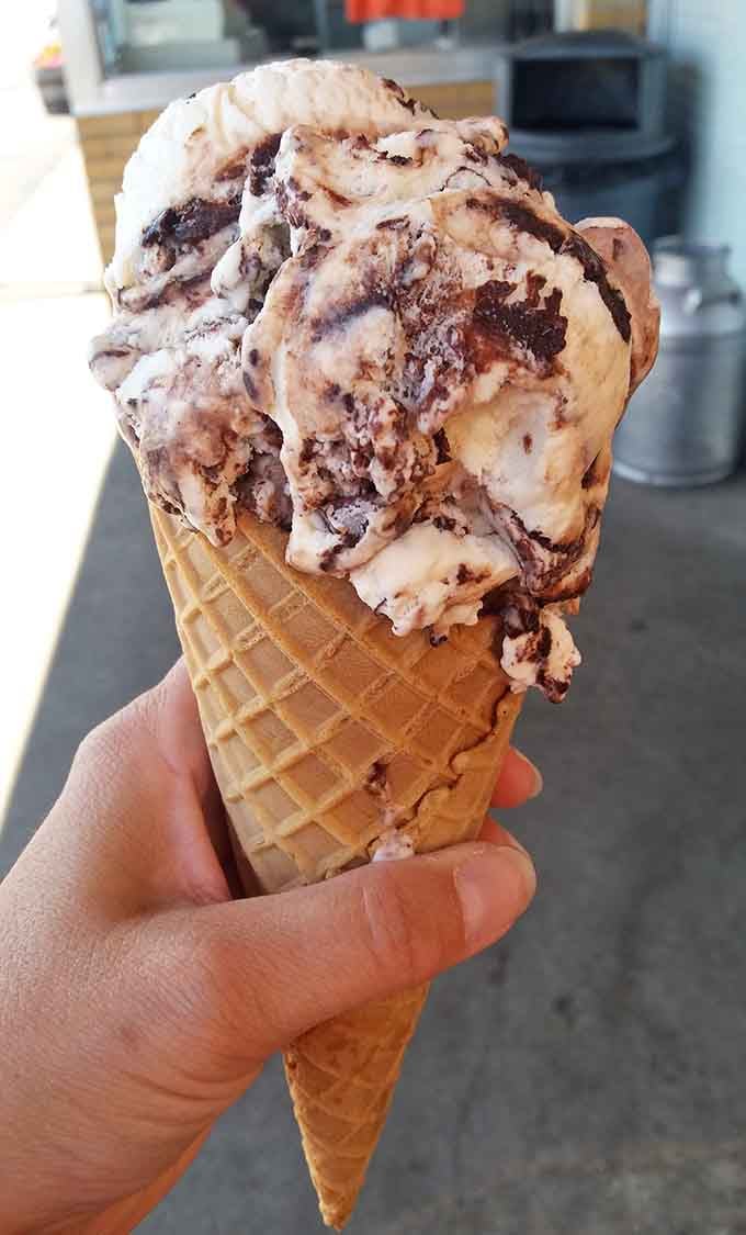 That generous scoop in a fresh waffle cone is basically summer vacation captured in edible form.