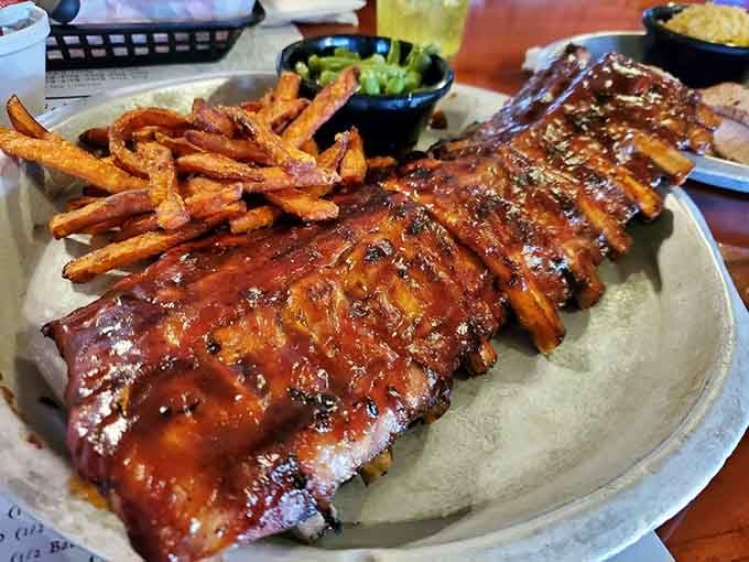 A full rack glistening with sauce is basically a love letter written in smoke and spice.