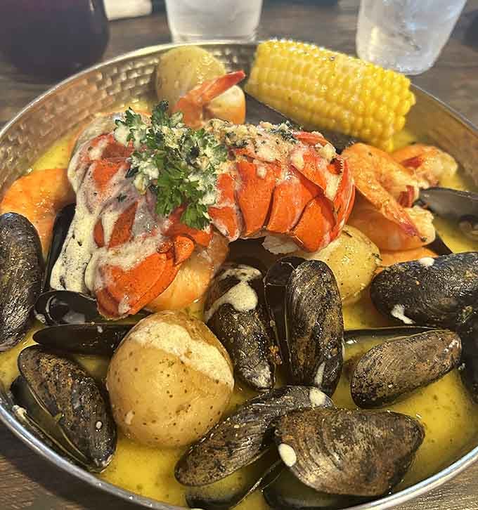 A seafood feast fit for Neptune himself, complete with lobster tail, mussels, and potatoes swimming in buttery glory.