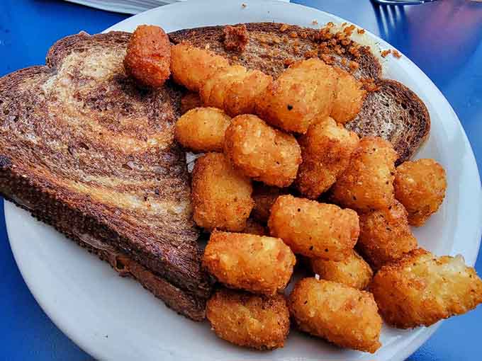 Golden grilled cheese meets crispy tater tots in a combination that makes perfect sense after the second beer.
