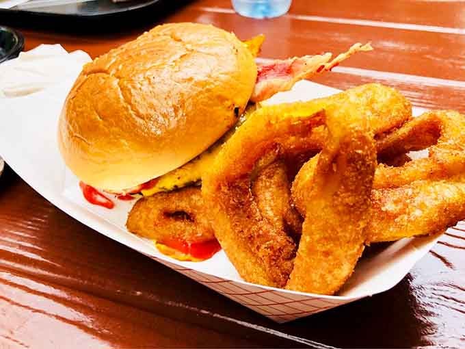 A bacon cheeseburger paired with onion rings: because sometimes you need to commit fully to indulgence.