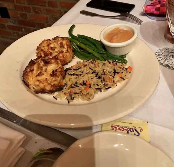 Crab cakes so golden they practically glow, served with rice that's dressed to impress.