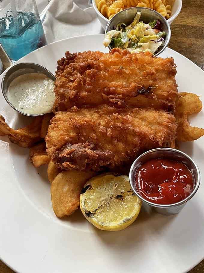 Golden, crispy fish and chips that would make any British pub jealous, served with all the fixings you need.
