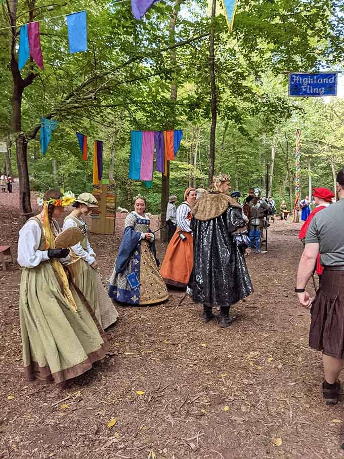 The royal court processes through the grounds, complete with elaborate costumes that put your Halloween efforts to shame.