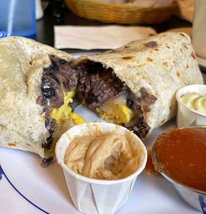 That breakfast burrito cross-section reveals eggs, meat, and cheese in perfect harmony, wrapped up like a delicious morning present.