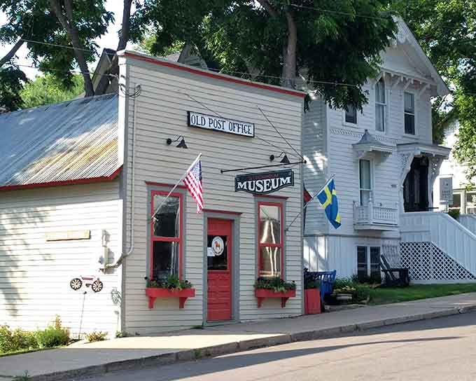 The old post office turned museum stands proud with its red trim, preserving stories from when stamps cost pennies.