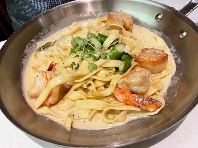 Silky fettuccine with perfectly seared scallops and shrimp proves that simple ingredients become magic in skilled hands.