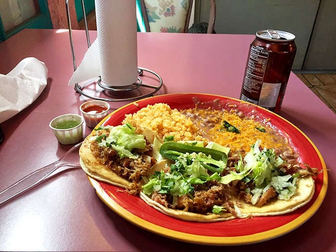 A red plate piled high with street tacos and sides: this is what winning at lunch looks like.