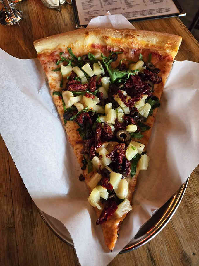 The Sweet Mia pizza proves that artichokes and sun-dried tomatoes belong together like peanut butter and jelly, only fancier.