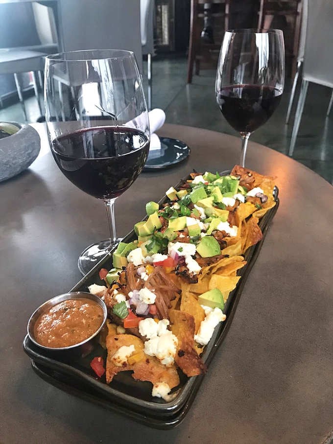 These nachos arrive like a mountain of deliciousness, proving that sometimes excess is exactly what the doctor ordered, metaphorically speaking.