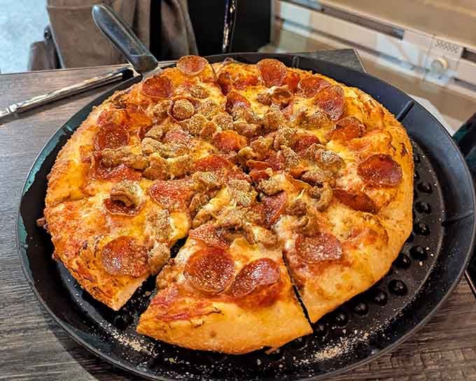 Pepperoni and mushrooms covering every square inch, because apparently moderation is just a suggestion around here.