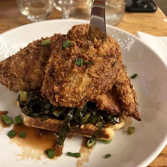 Crispy, golden, and perched atop fluffy waffles, this chicken knows exactly what it's doing to your willpower.