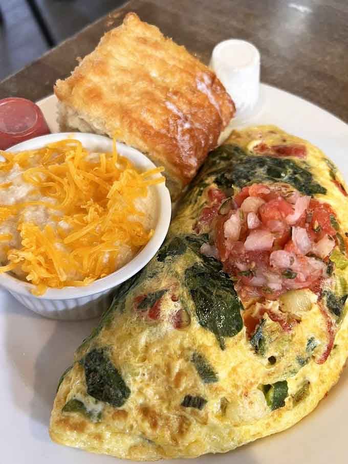 That omelet paired with a towering biscuit is proof that some relationships are just meant to be together.