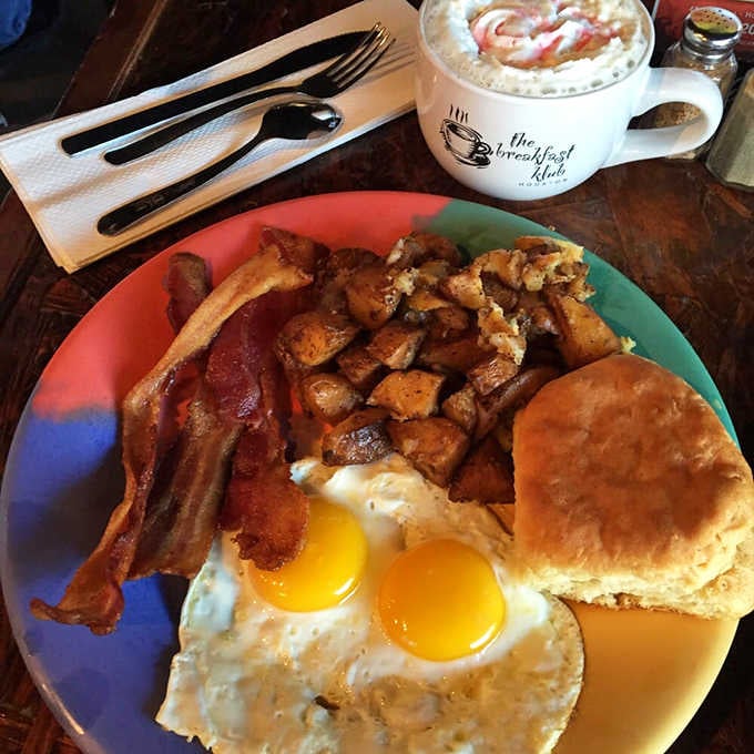 Eggs, bacon, home fries, and a biscuit on one plate: this is what mornings were meant to look like.