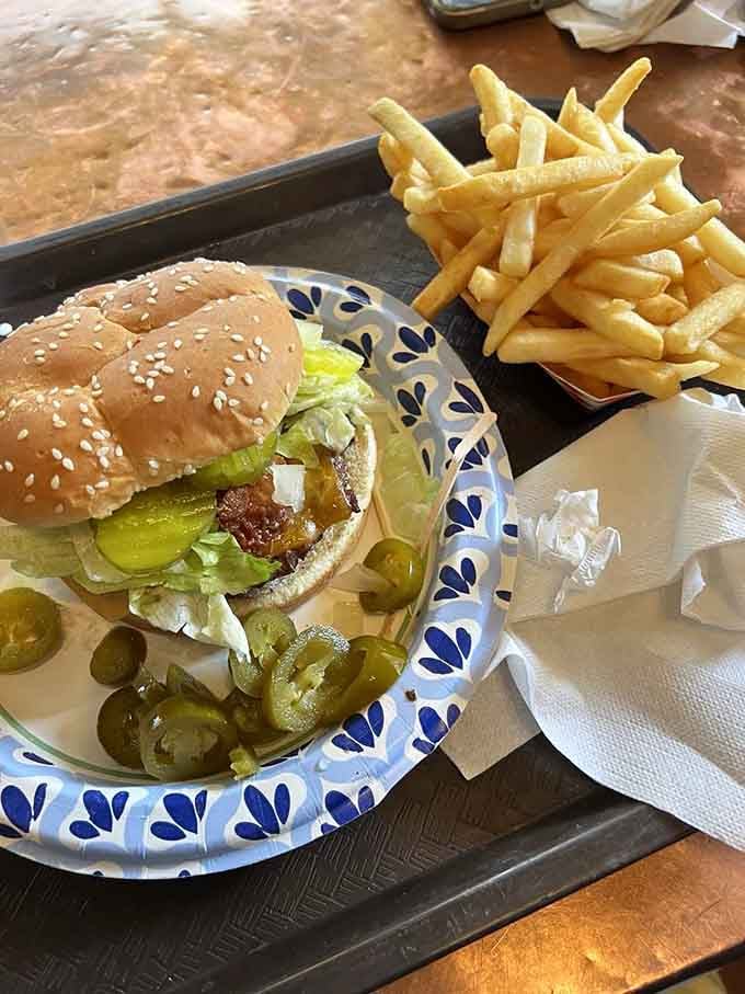 That sesame seed bun, melted cheese, and pile of fries represent everything right with American comfort food done properly.