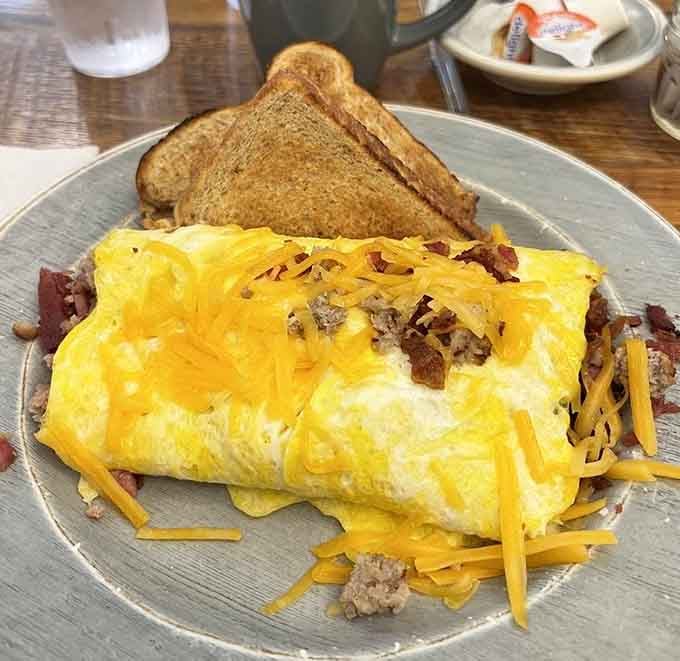 This omelet is stuffed so full of meat and cheese, it practically needs its own table to sit at.