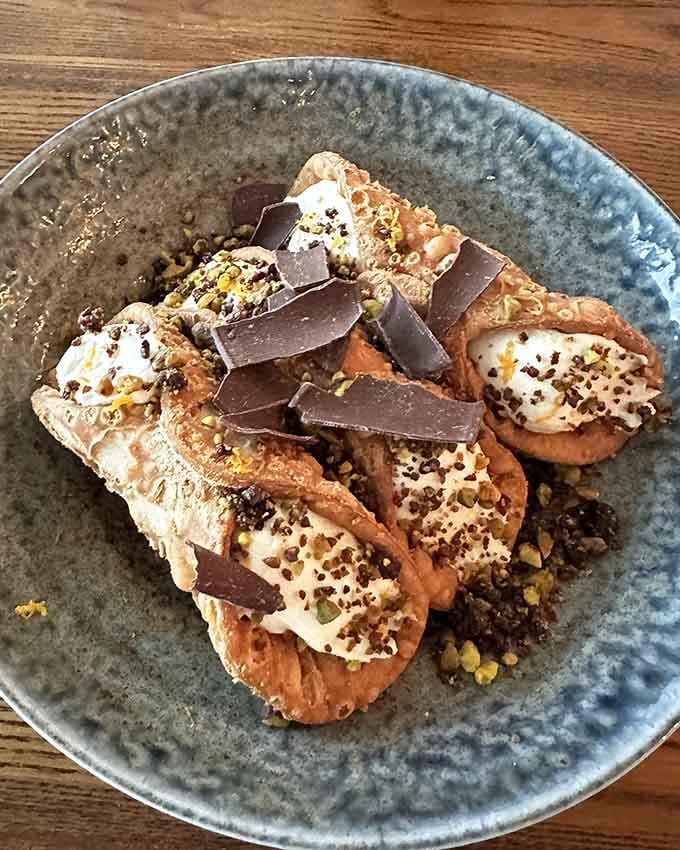 Cannoli topped with chocolate shavings and cream prove that dessert is always worth the extra calories tonight.