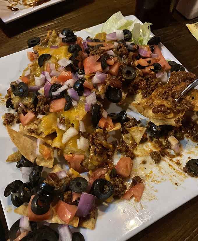 These nachos pile cheese, meat, olives, and toppings so high they'd make any stadium concession stand weep with envy.