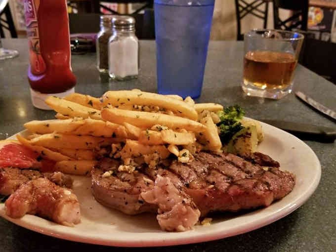 Perfectly grilled ribeye with a mountain of fries, because sometimes you need protein and carbs working together in harmony.