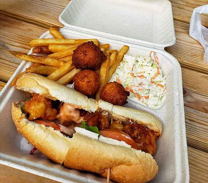 That oyster po' boy with hush puppies looks like happiness decided to take sandwich form for lunch.