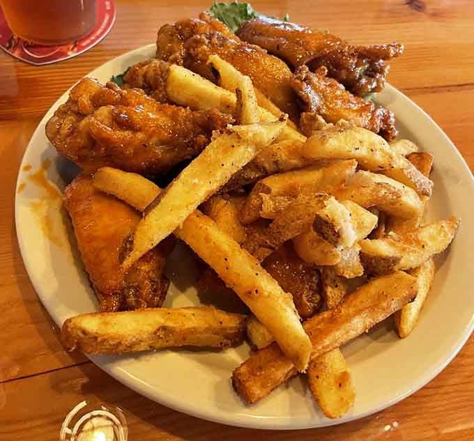 Wings and fries piled high enough to require air traffic control clearance before landing on your table.
