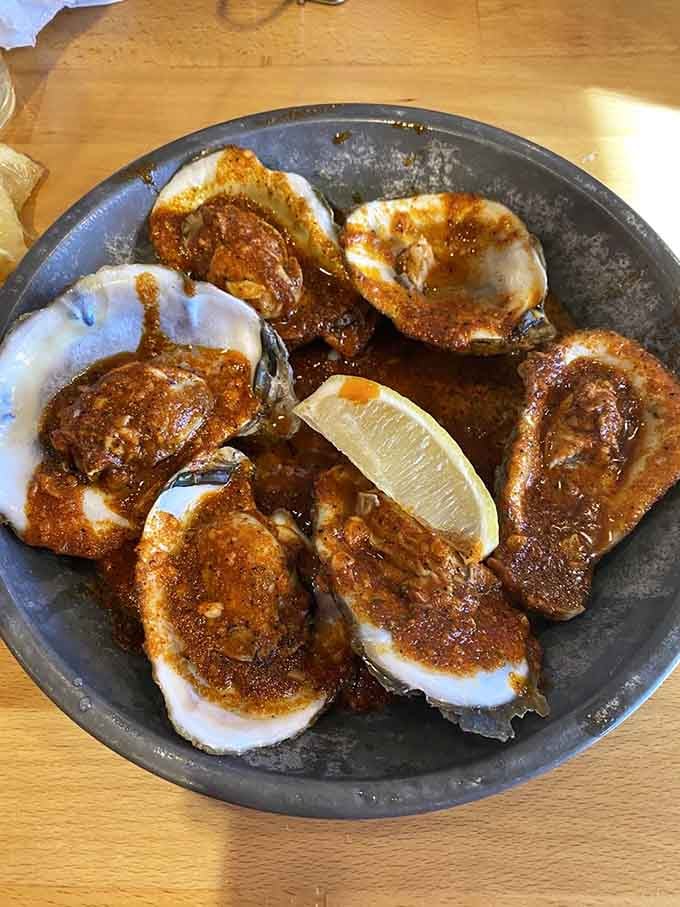 Steamed oysters glistening with seasoned butter prove that sometimes the simplest preparations create the most memorable flavors and experiences.