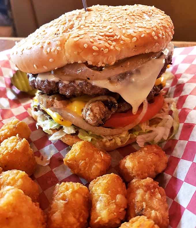 The Ultimate Logger Burger stacks double patties high enough to require architectural planning before your first bite.