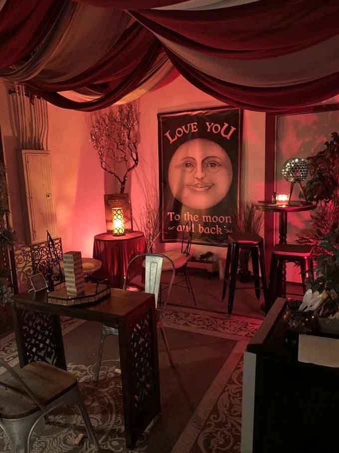 Draped fabric and soft pink lighting create an intimate space that feels like stepping into a Valentine's Day fantasy.