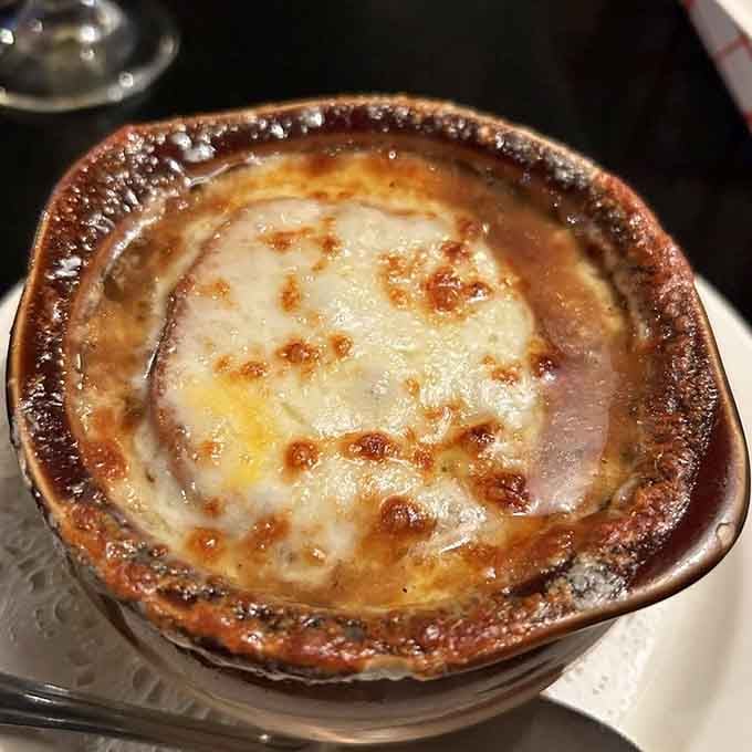 French onion soup with that gloriously melted cheese blanket, comfort in a crock that warms your soul completely.