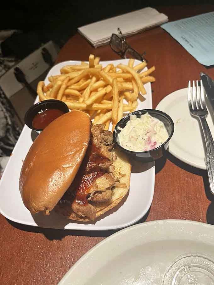 That pulled pork sandwich piled high with meat and served with crispy fries is pure comfort food perfection.