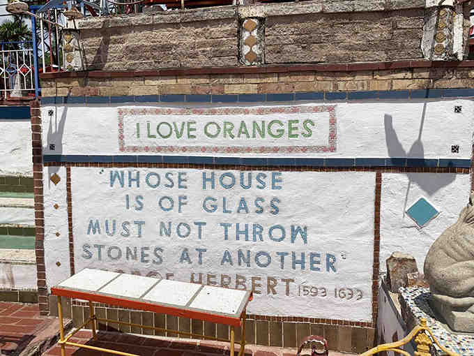 "I Love Oranges" declares this tile work, paired with wisdom about glass houses and stone throwing.